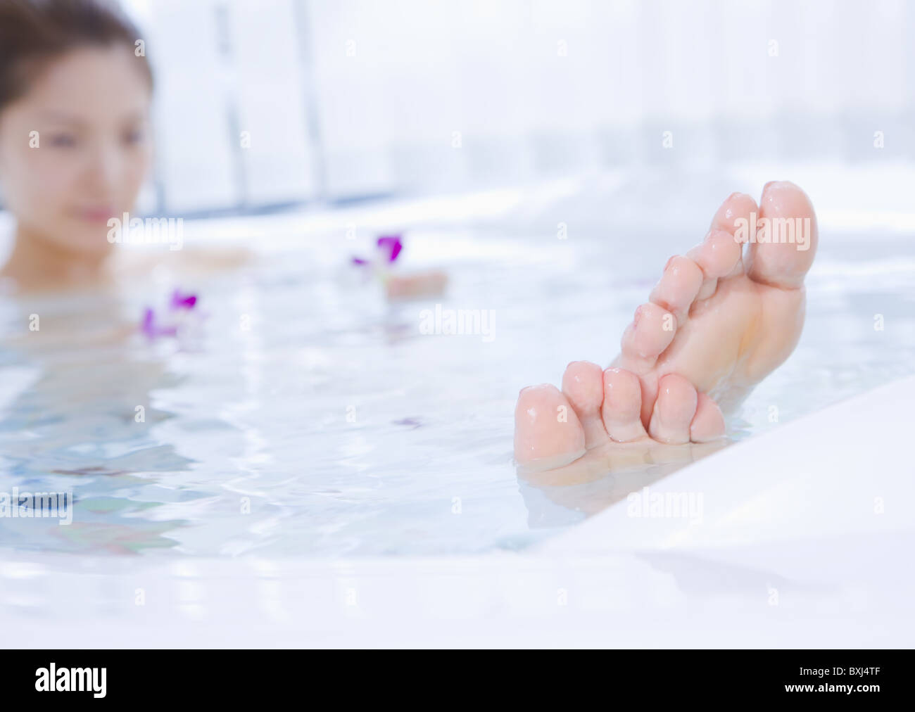 Woman's leg taking a bath, closeup Stock Photo - Alamy