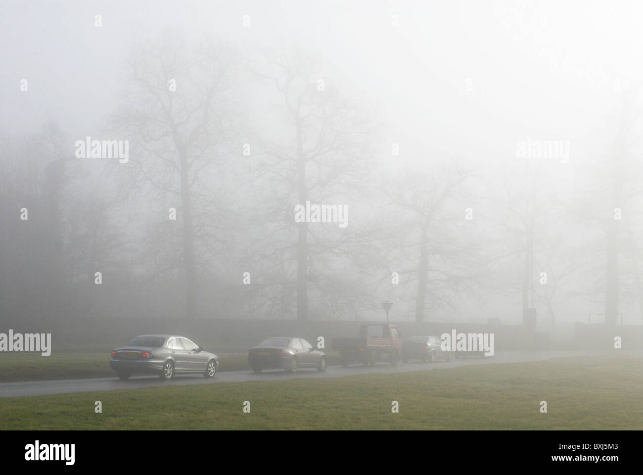 Cars driving in fog UK Stock Photo - Alamy