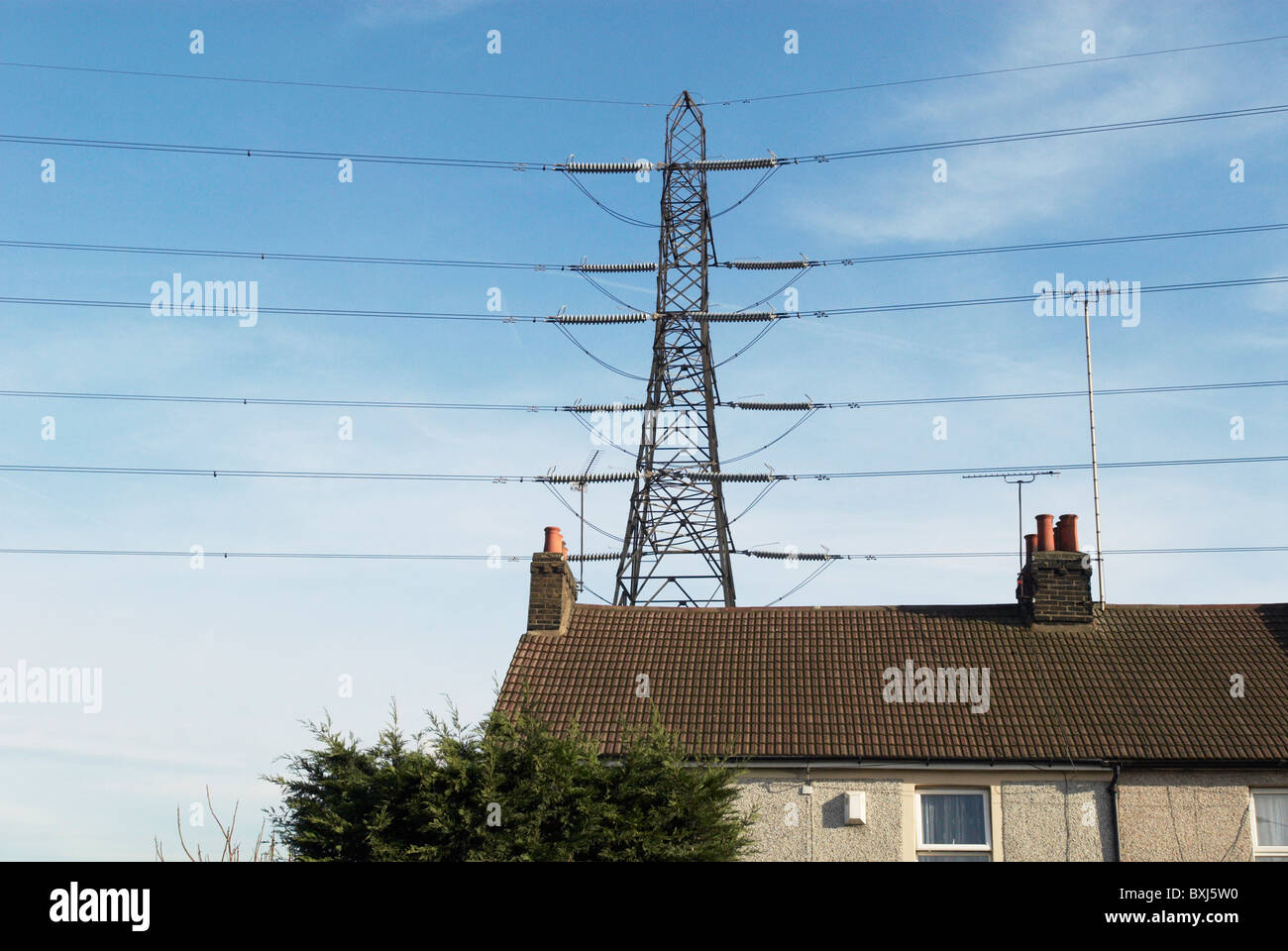Electricity pylon behind houses Greenhithe Kent UK Stock Photo - Alamy