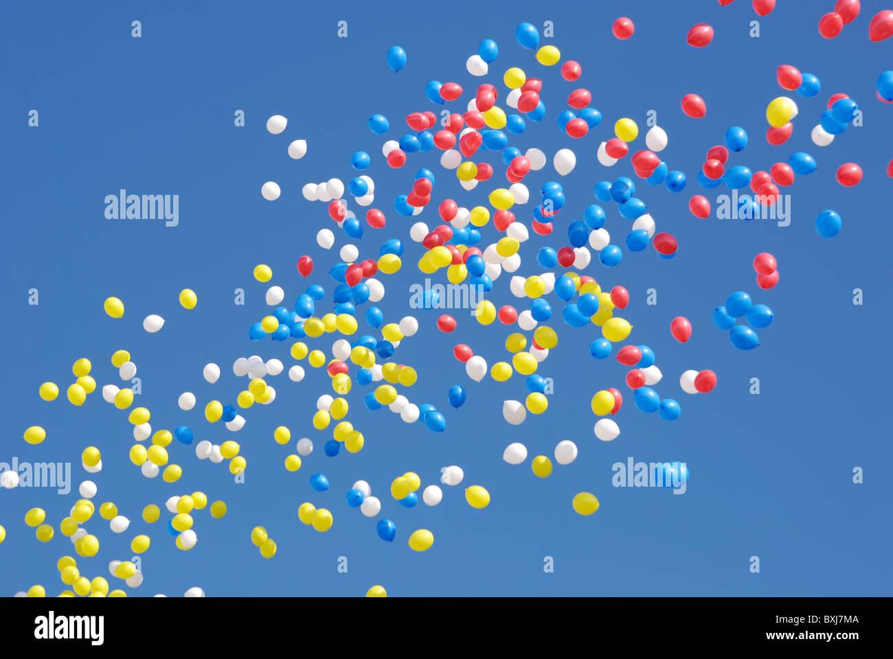 many-coloured balloons flying in blue sky Stock Photo - Alamy