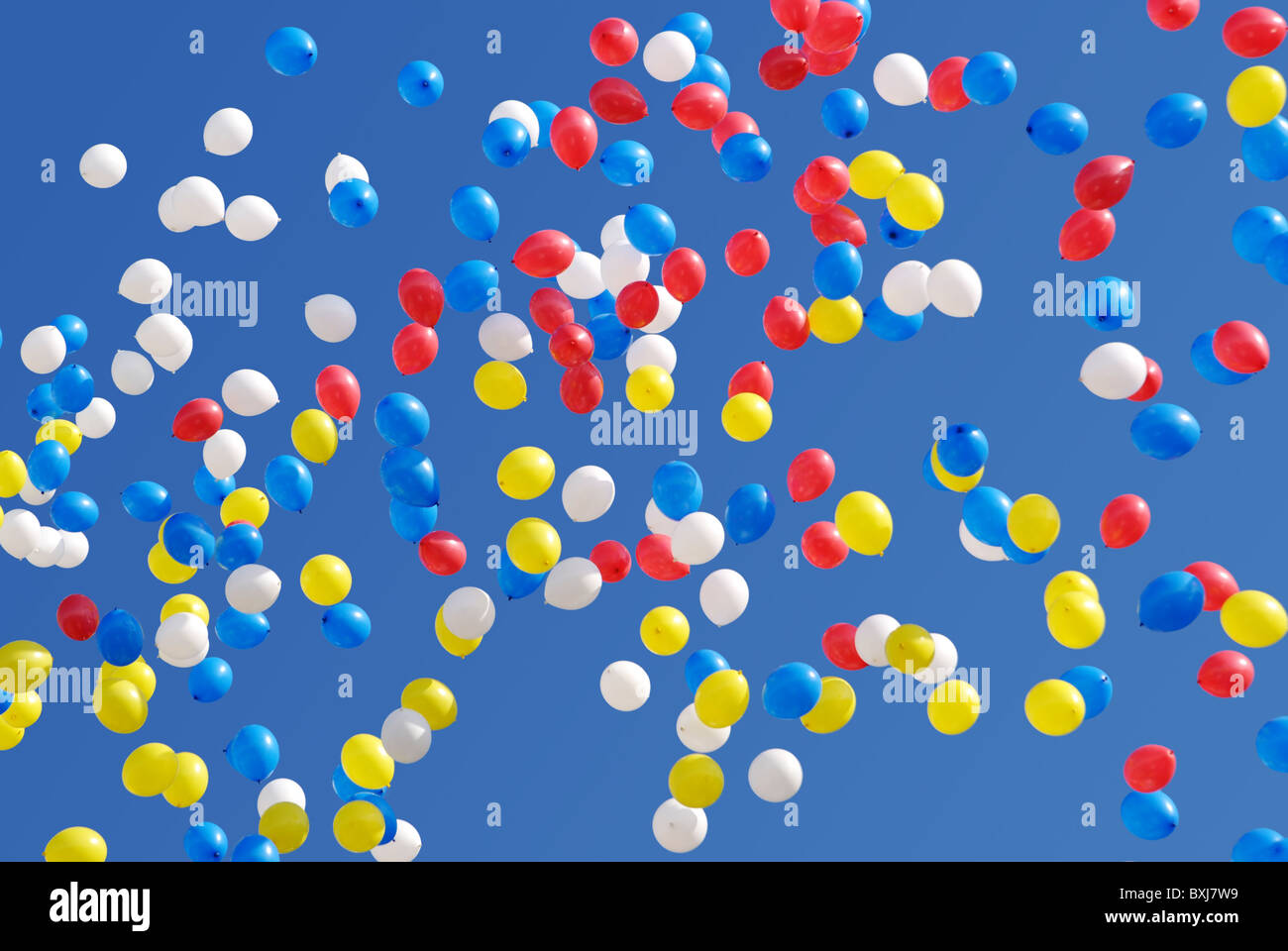 many-coloured balloons flying in blue sky Stock Photo - Alamy