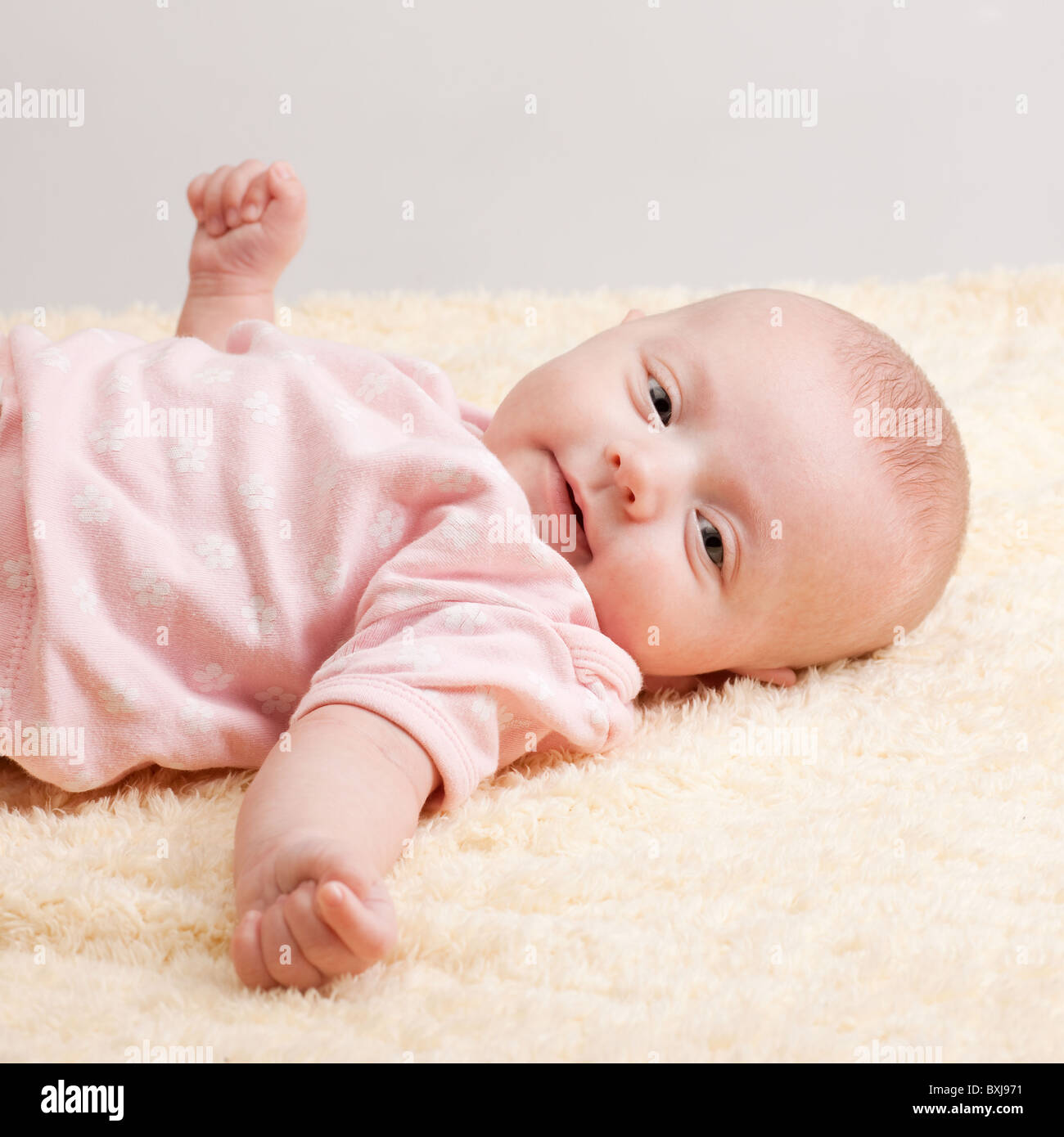 Calm relaxed beautiful little baby girl lying on furry blanket Stock ...