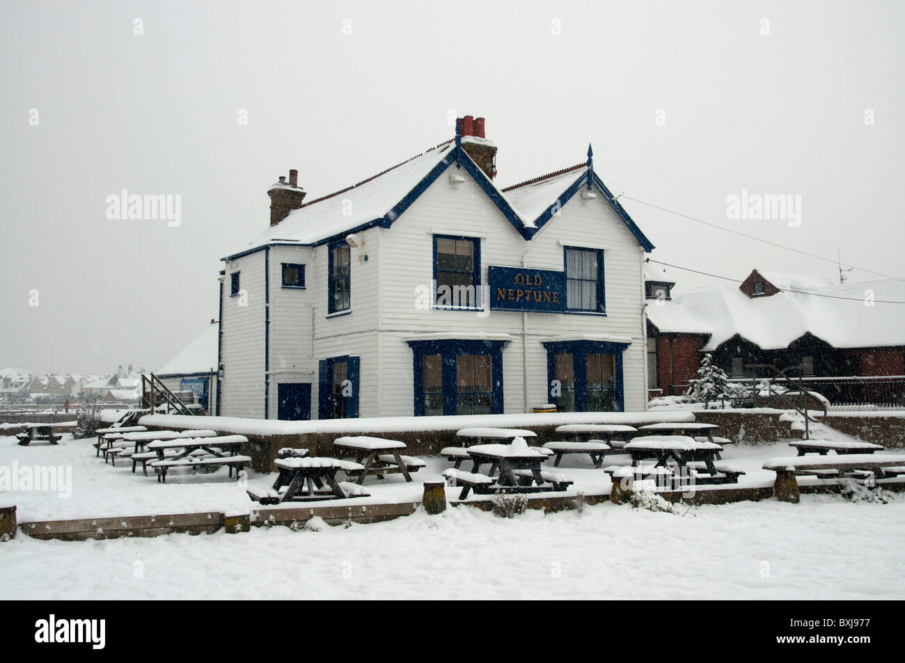 Snow falling Whitstable Kent neptune public house on the beach Stock ...