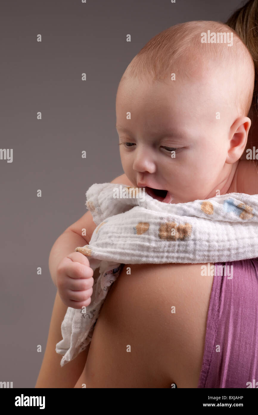 Little ten weeks old baby girl on mother shoulder Stock Photo - Alamy
