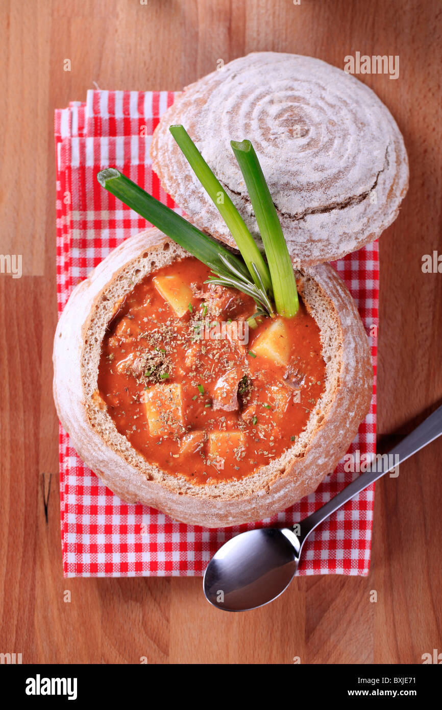 Goulash served in a bread bowl - overhead Stock Photo - Alamy