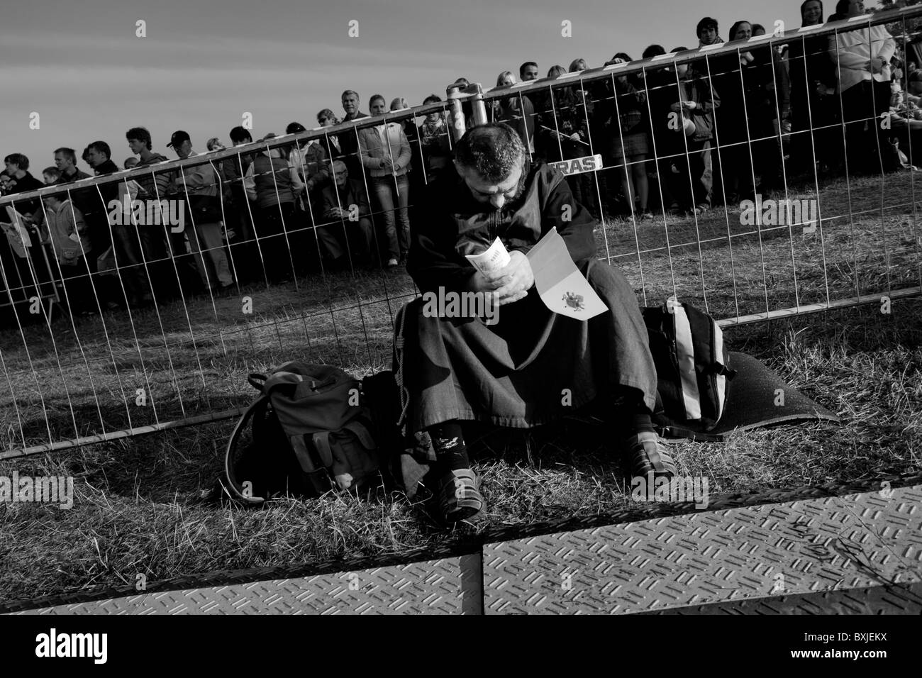 A monk, holding the Vatican flag, praying during the mass served by the ...