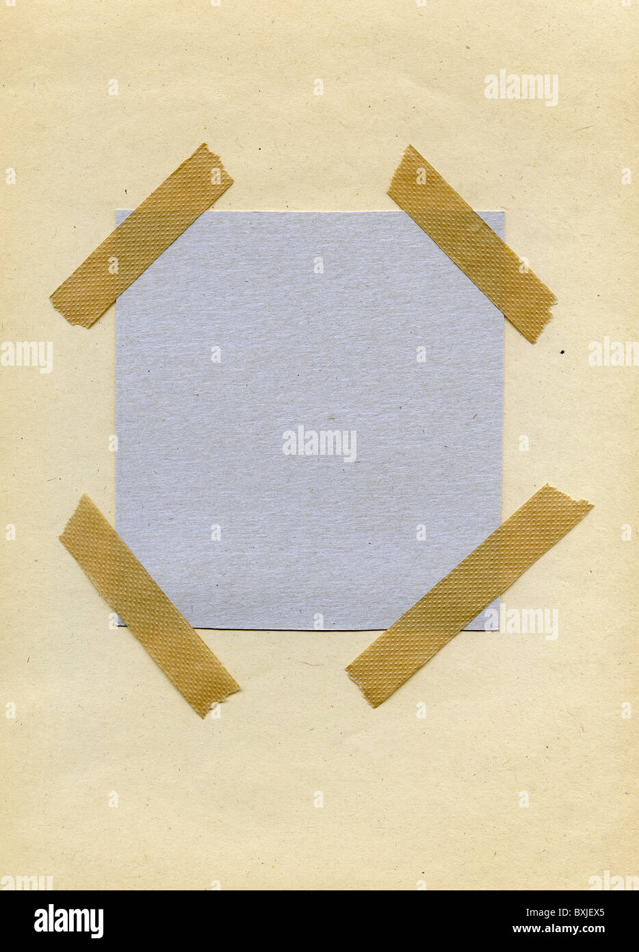 Cardboard sticked on textured recycled paper background Stock Photo - Alamy