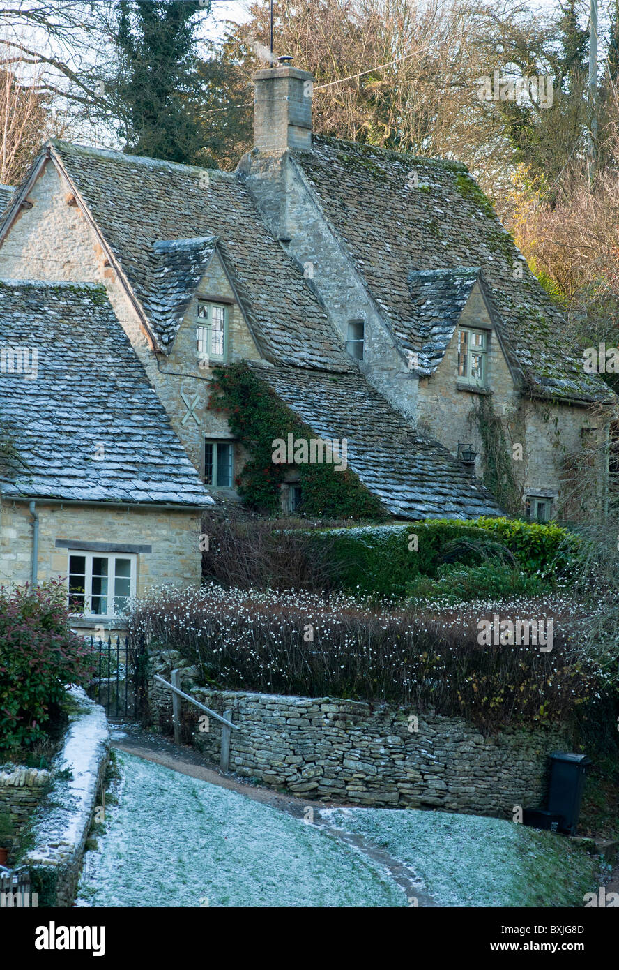 A rustic cottage on a cold frosty morning in the Cotswold village of ...