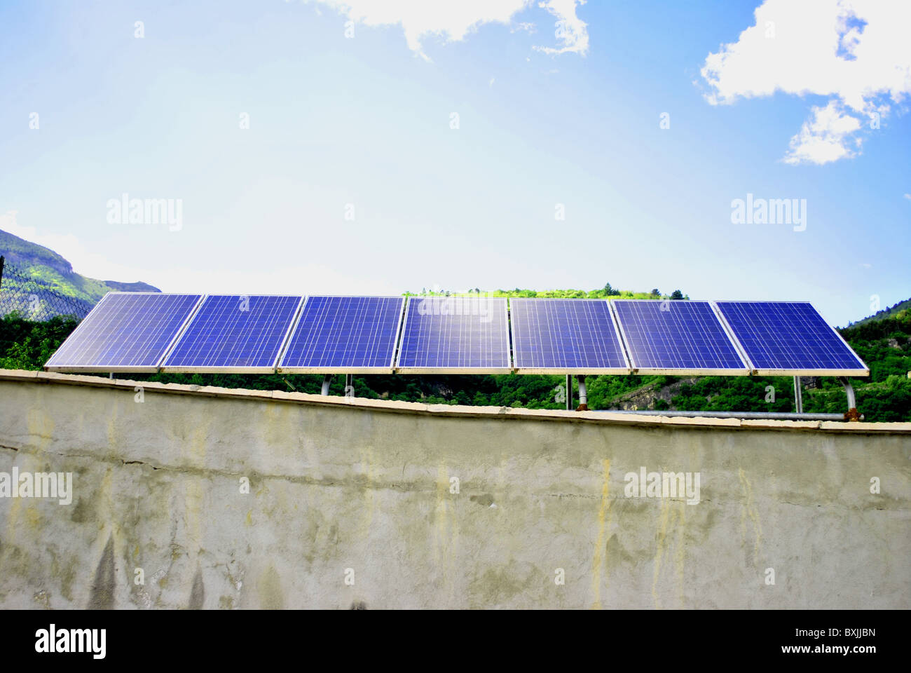 brick house with a roof and solar panels to produce electricity from ...