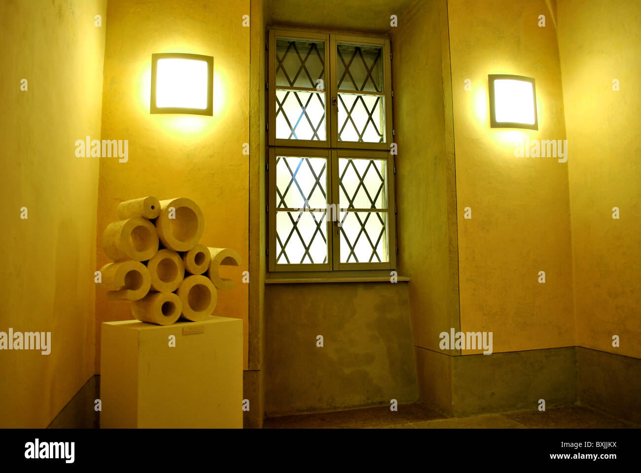 corridor with artificial lamps to light yellow with a window protected ...