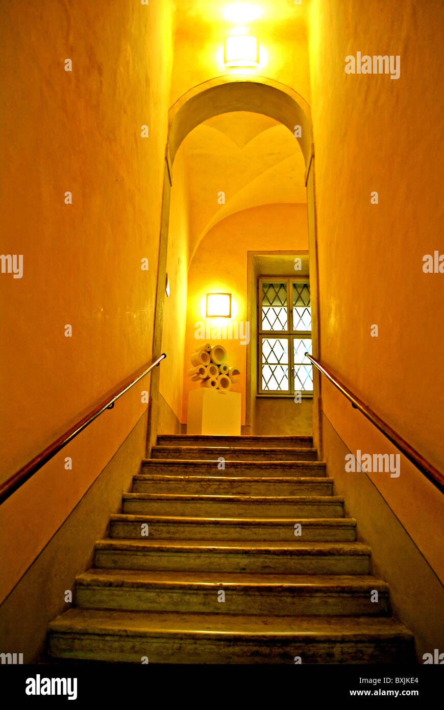 corridor with artificial lamps to light yellow with a window protected ...