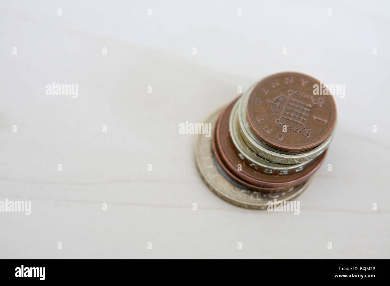 A small stack of different denomination sterling coins, which includes ...