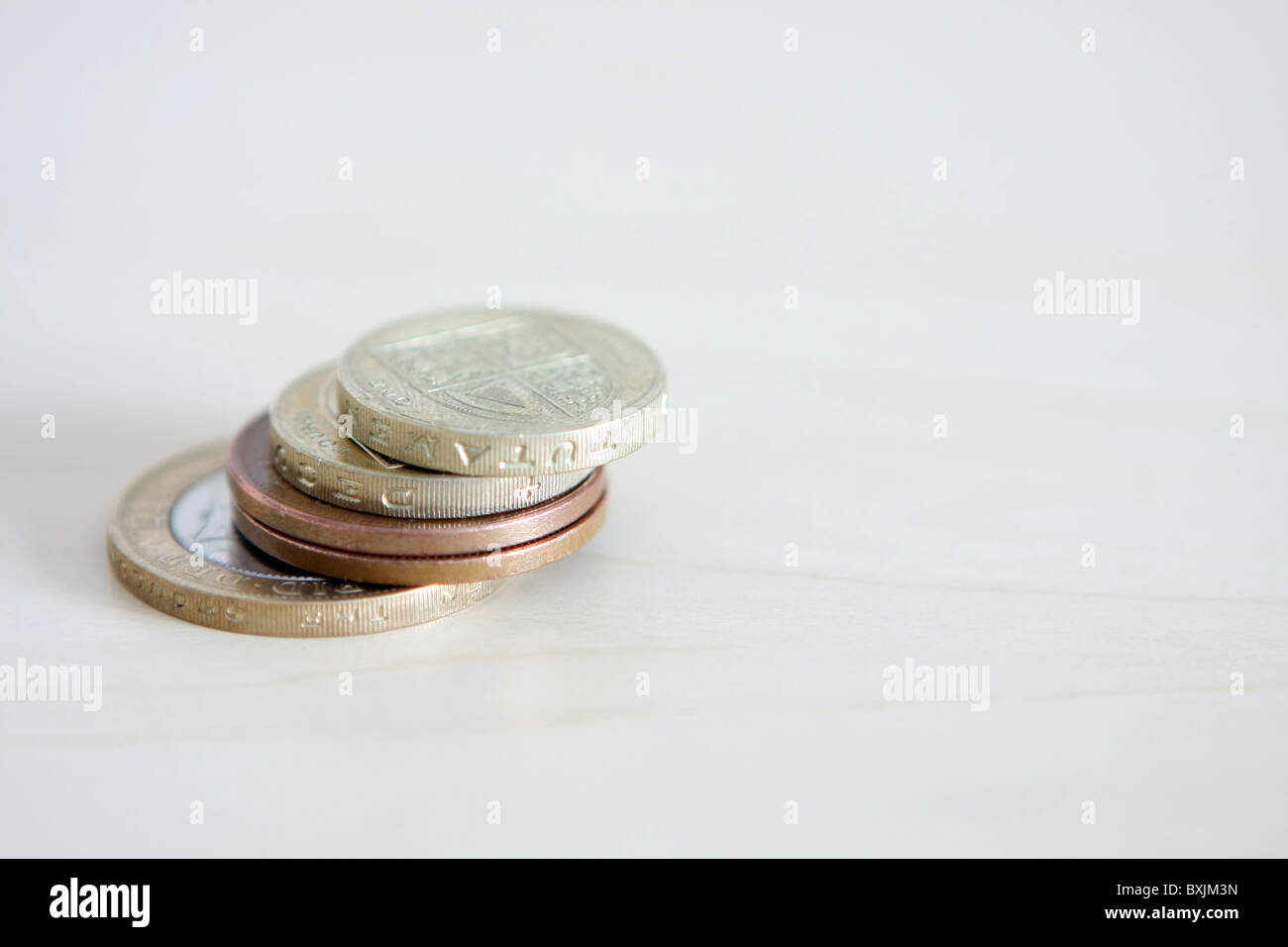A small stack of different denomination sterling coins, which includes ...