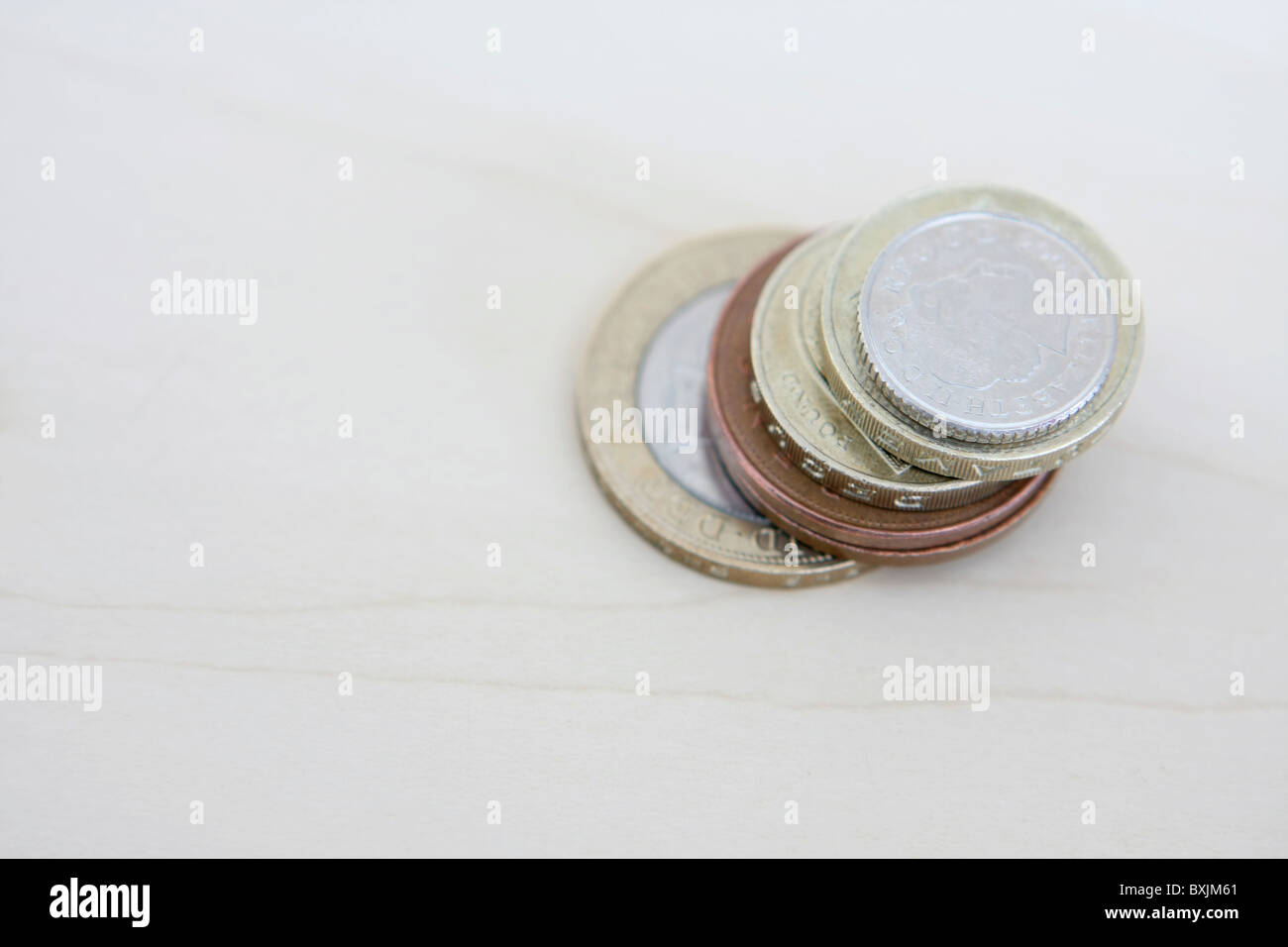A small stack of sterling coins, which includes £2, £1, 2p and 5p coins ...