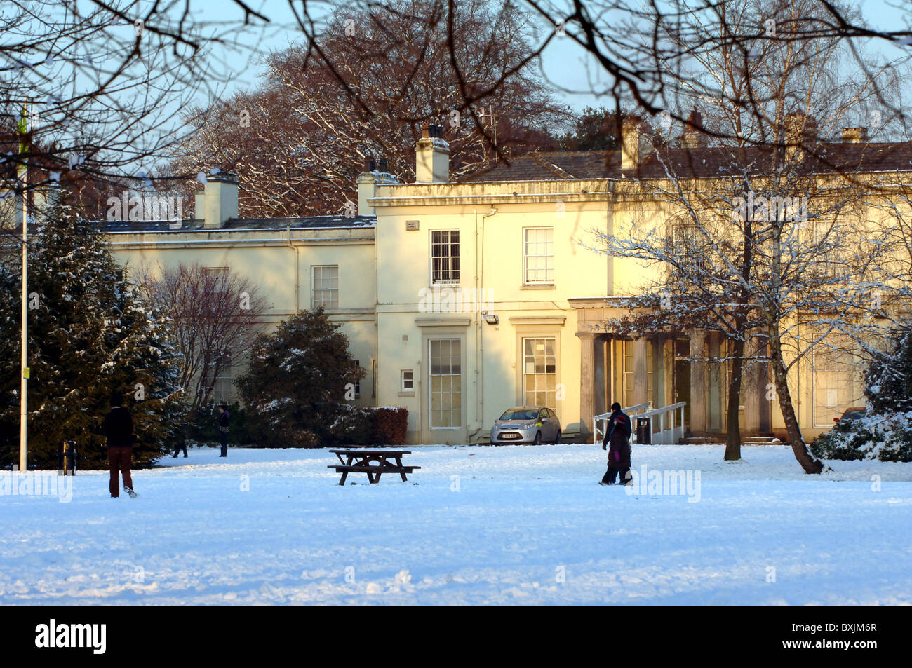 A mansion house in a snow covered park at sunset Stock Photo - Alamy