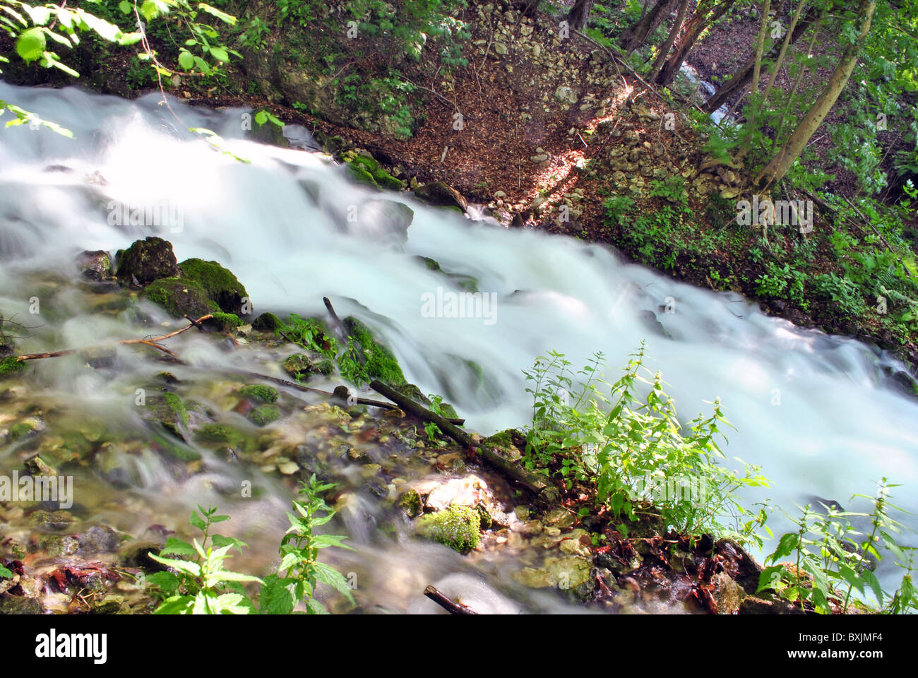 land which is fresh water with a waterfall and rushing noise coming ...