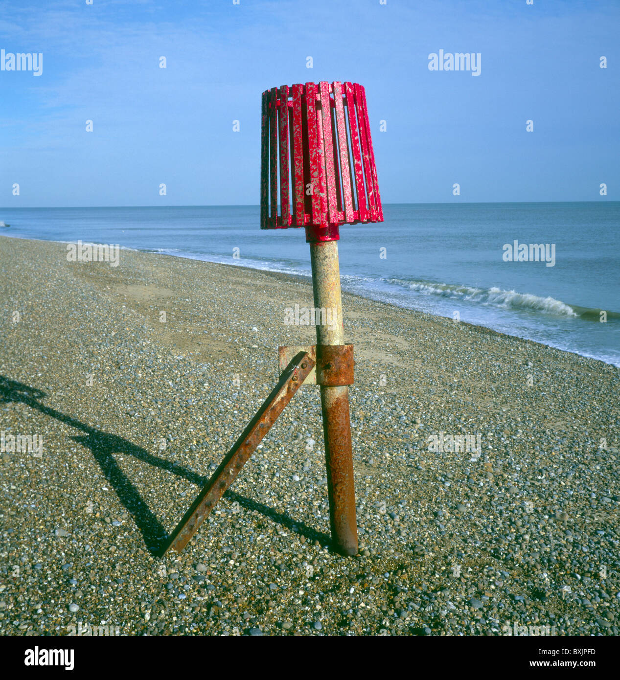 Red groyne marker on beach, groyne submerged by shingle sediment ...
