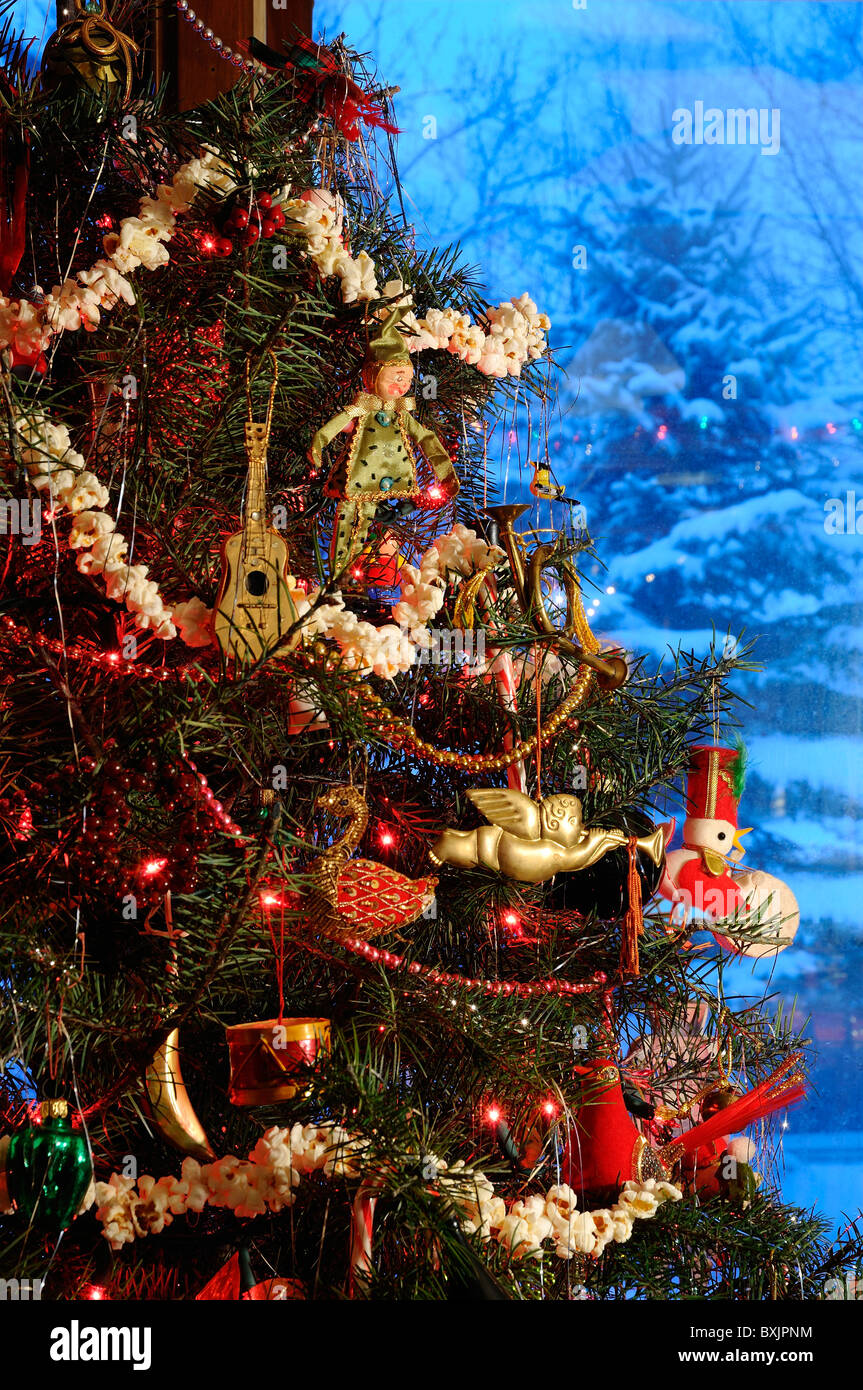 Christmas tree and a view of winter dusk outside the window Stock Photo ...