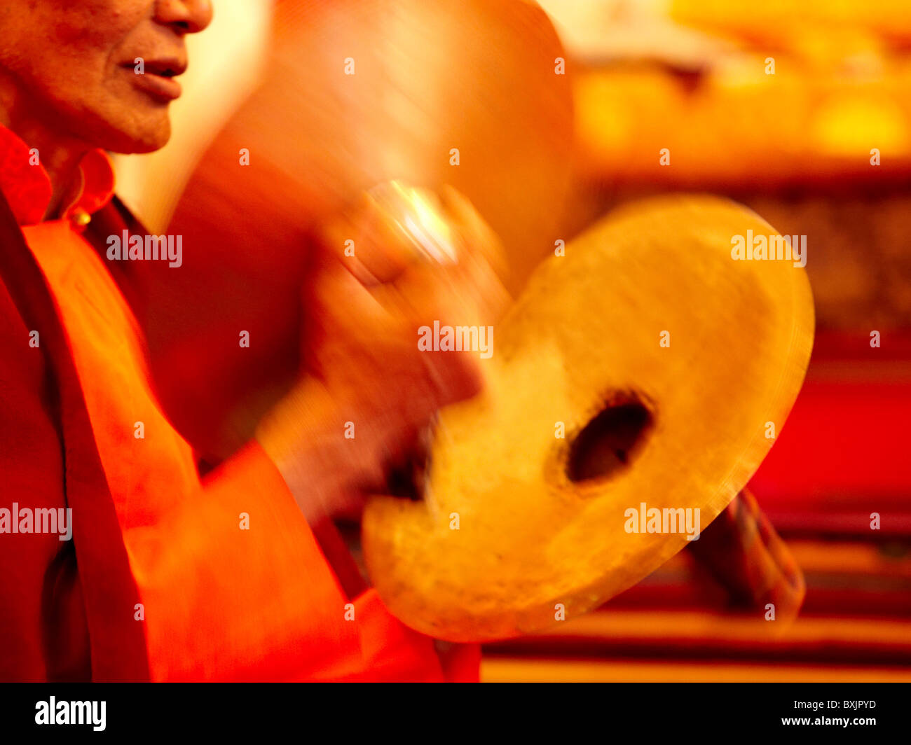 Buddhist monk playing cymbals Stock Photo - Alamy