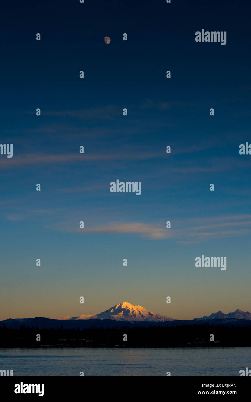 Sunset light touches Mt. Baker, Washington just after the moon rises ...