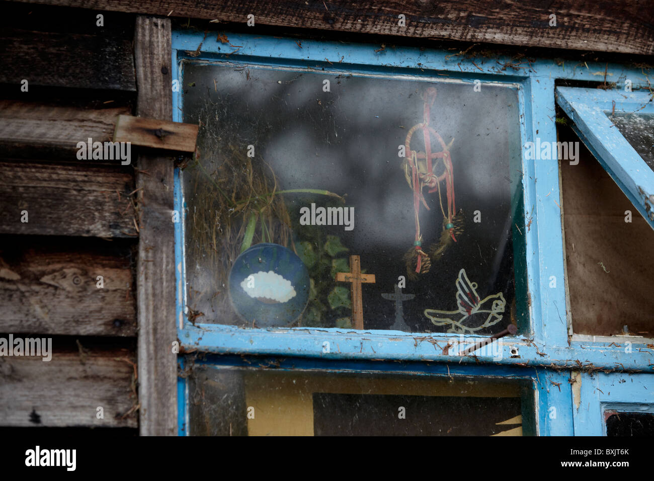 Run down shed/cabin with blue rotting wooden window frame Stock Photo ...