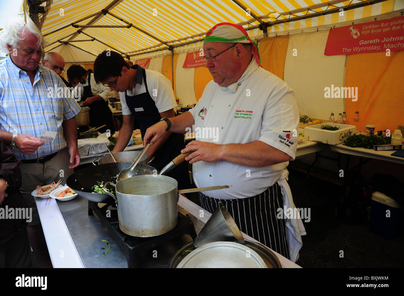 a cook demonstrates how to cook fish at the seafood festival in ...
