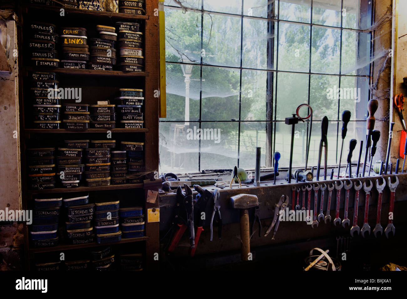 An old workbench bench with tools beneath a window in a workshop Stock ...