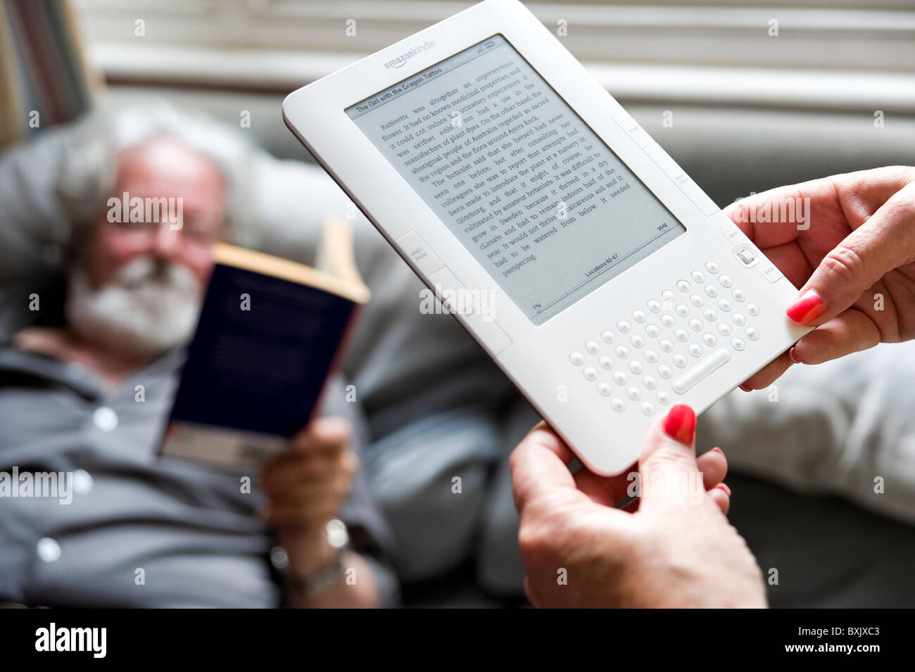 Reading book on Amazon Kindle Stock Photo - Alamy