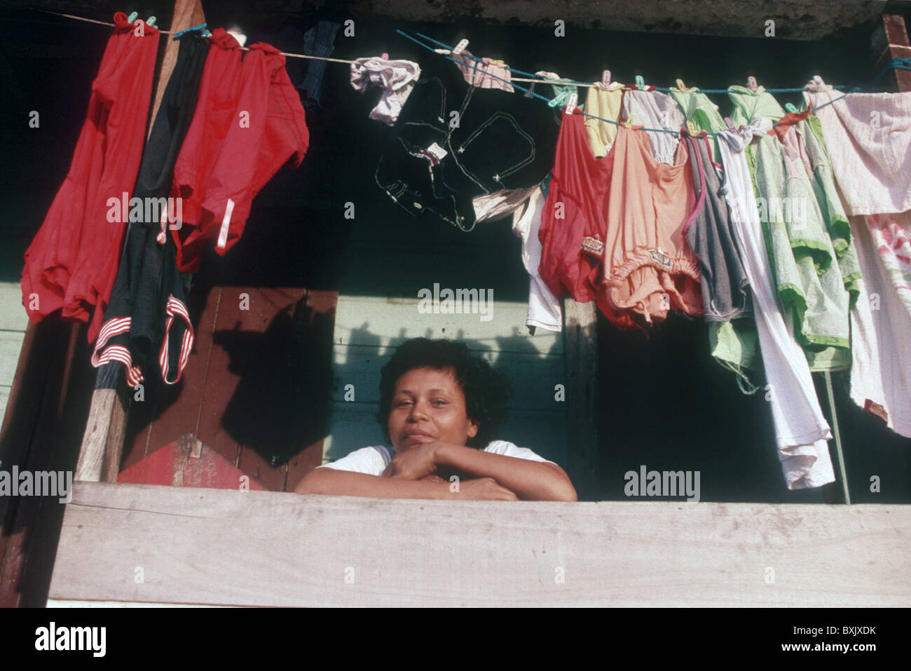 PANAMA. NATIVE GUAYMI WOMAN IN BALCONY WITH CLOTHES DRYING ON CARIBBEAN ...