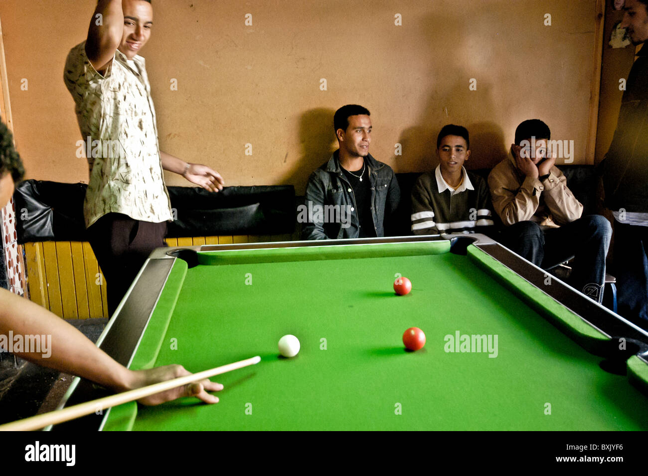 Young Males playing pool in a bar in a shanty town outside Casablanca ...