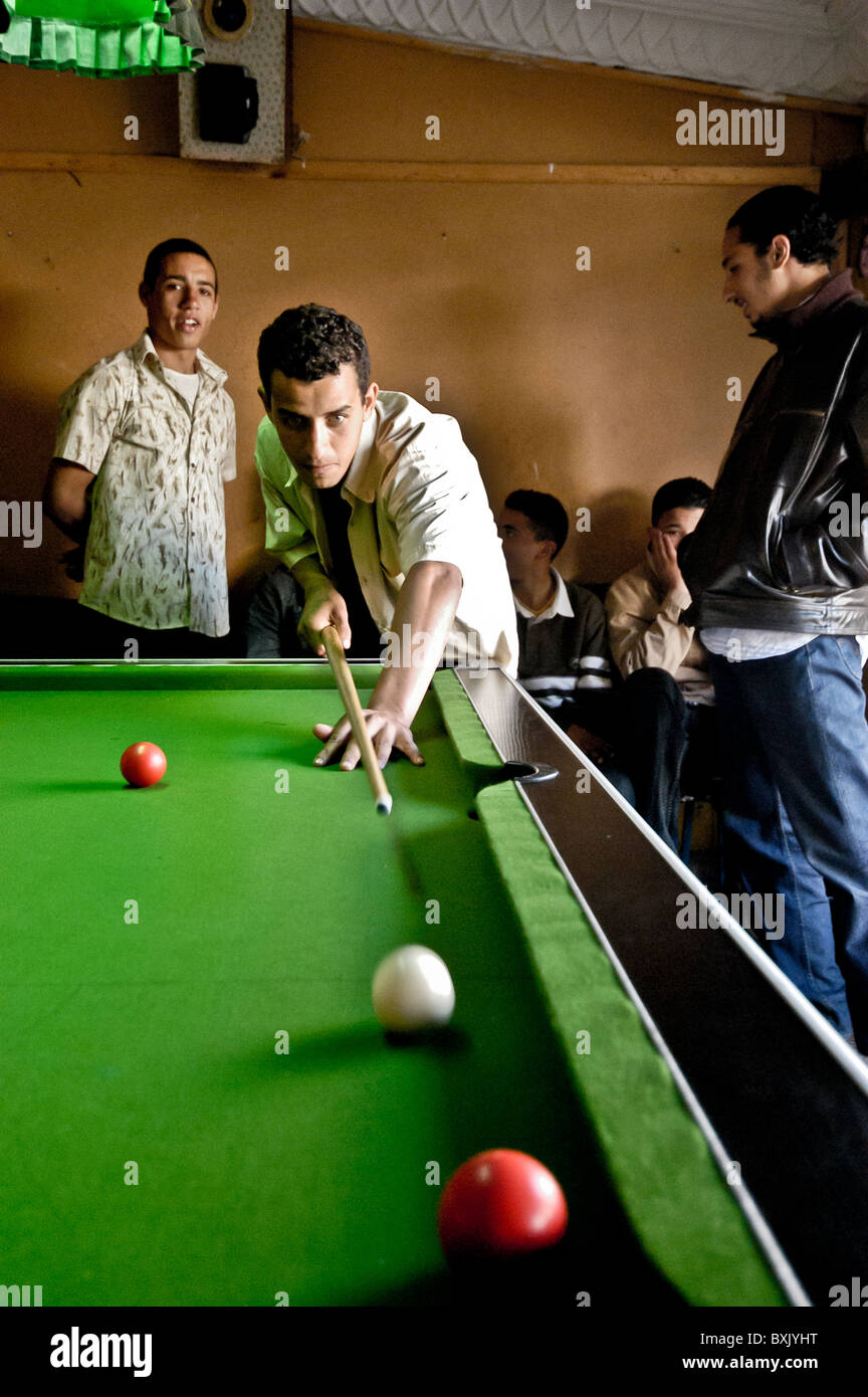Young Males playing pool in a bar in a shanty town outside Casablanca ...