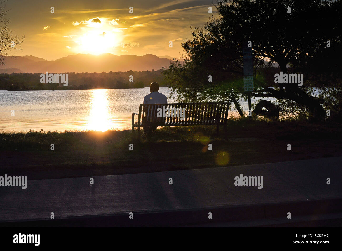 silhouette man lake water reflection sunset Stock Photo - Alamy
