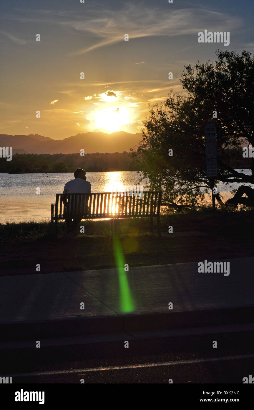 silhouette man lake water reflection sunset Stock Photo - Alamy