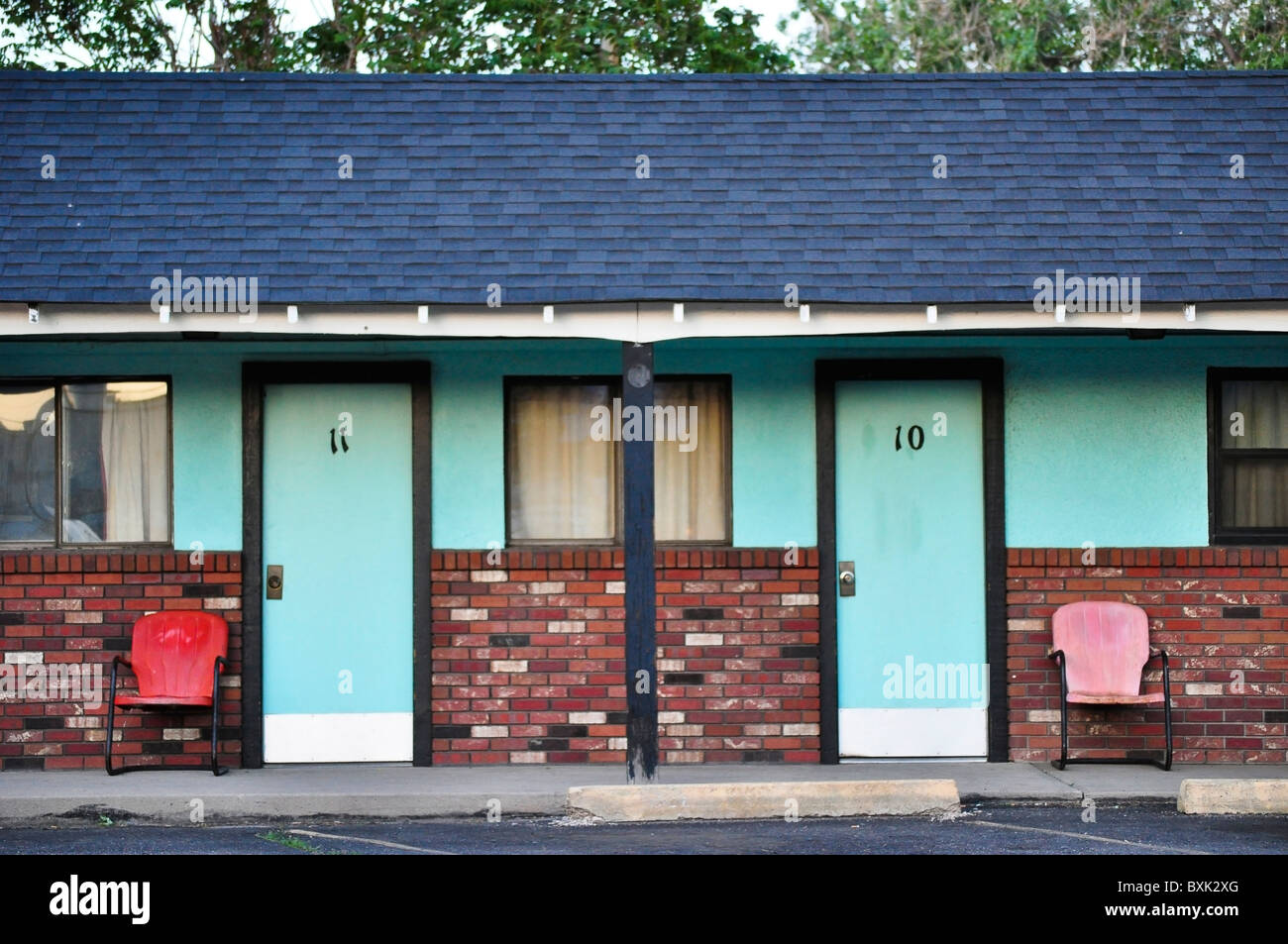 old motel with doors and colorful chairs Stock Photo - Alamy