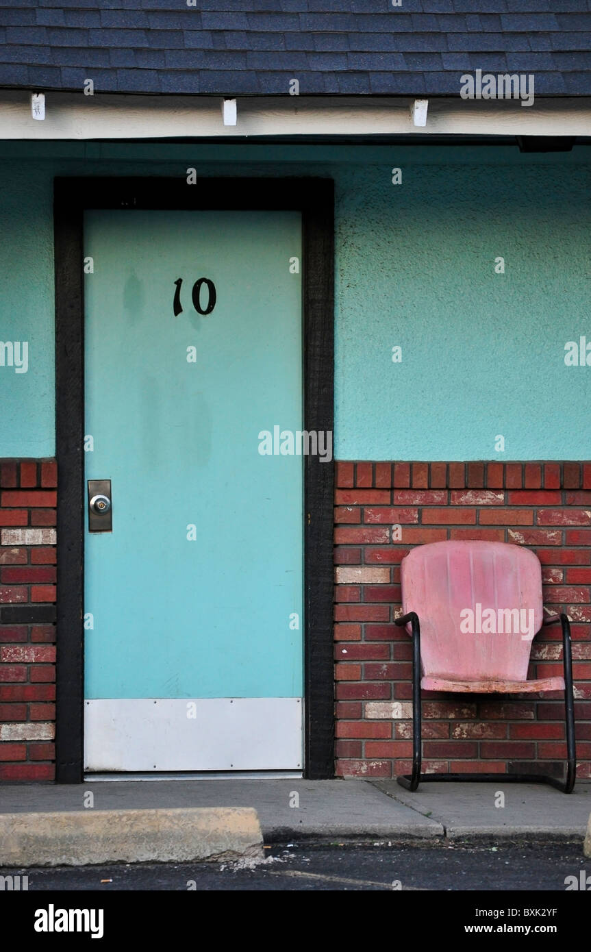 old motel with doors and colorful chairs Stock Photo - Alamy