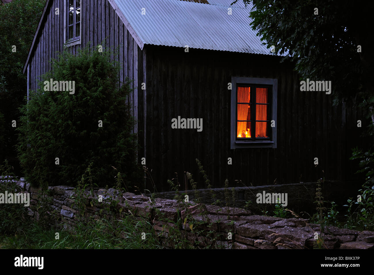 Light in a window of an old wooden house a summer night Stock Photo - Alamy