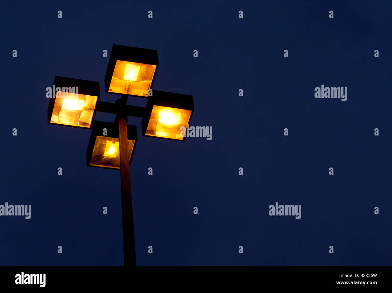 Illuminated halogen street light at night with dark background Stock ...