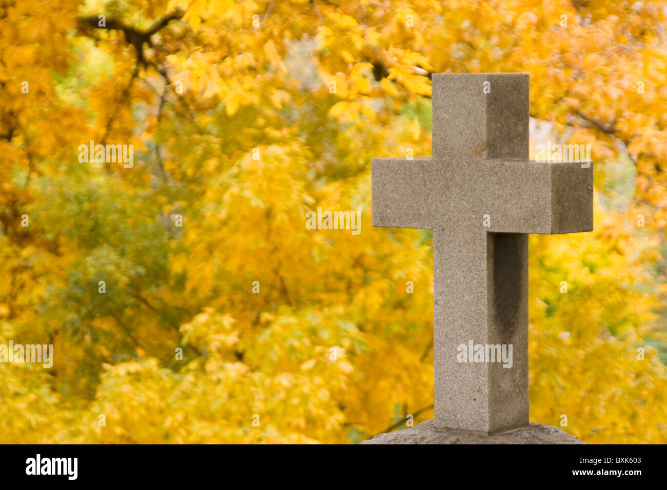 Stone cross with autumn trees background Stock Photo - Alamy