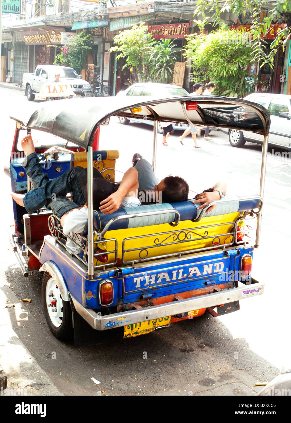Tuk Tuk drivers hang out in the back of a tuk-tuk in Bangkok Stock ...