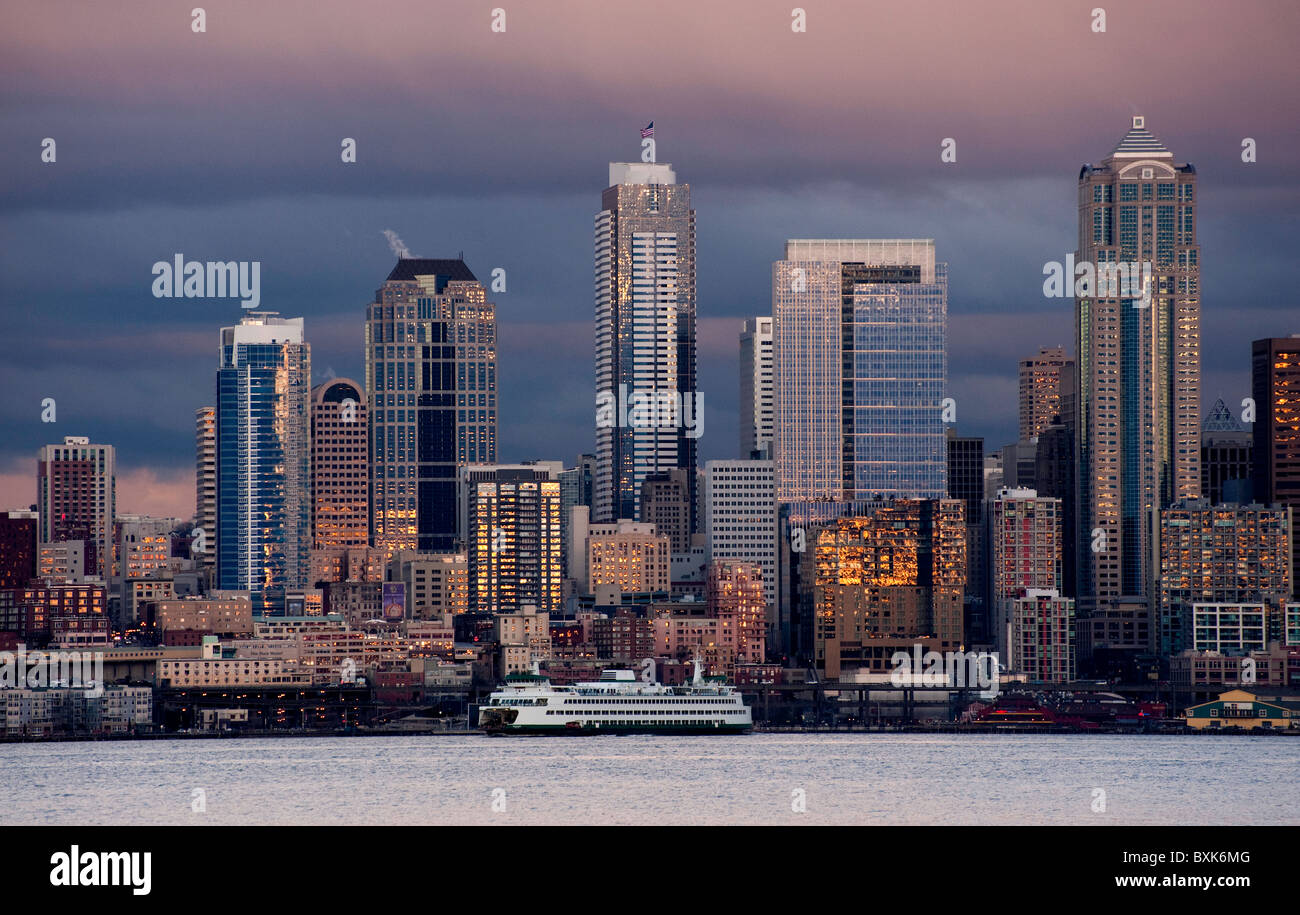 At sunset a ferry prepares to dock at the Seattle, Washington ...