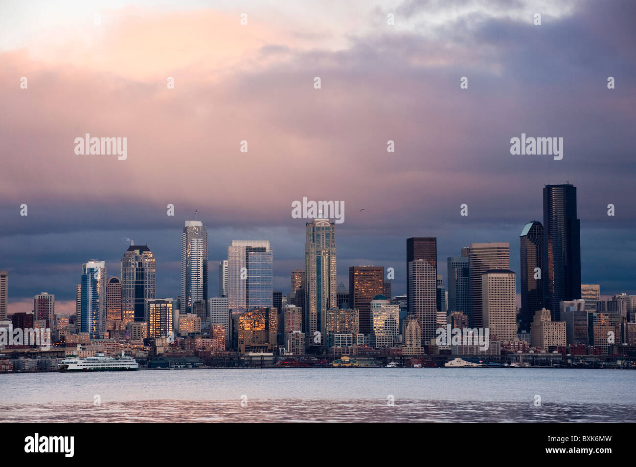 At sunset a ferry prepares to dock at the Seattle, Washington ...