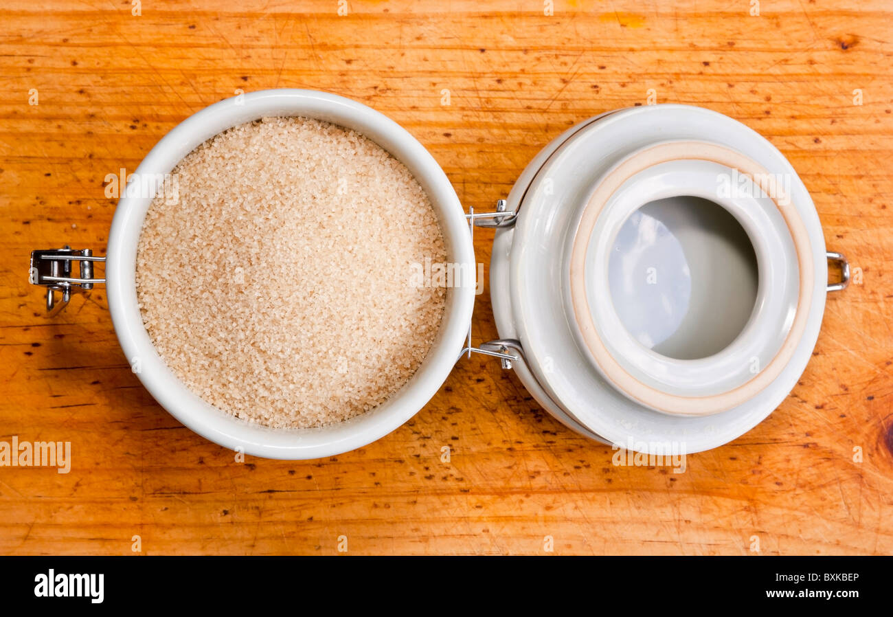 An open sugar jar on a timber surface Stock Photo - Alamy