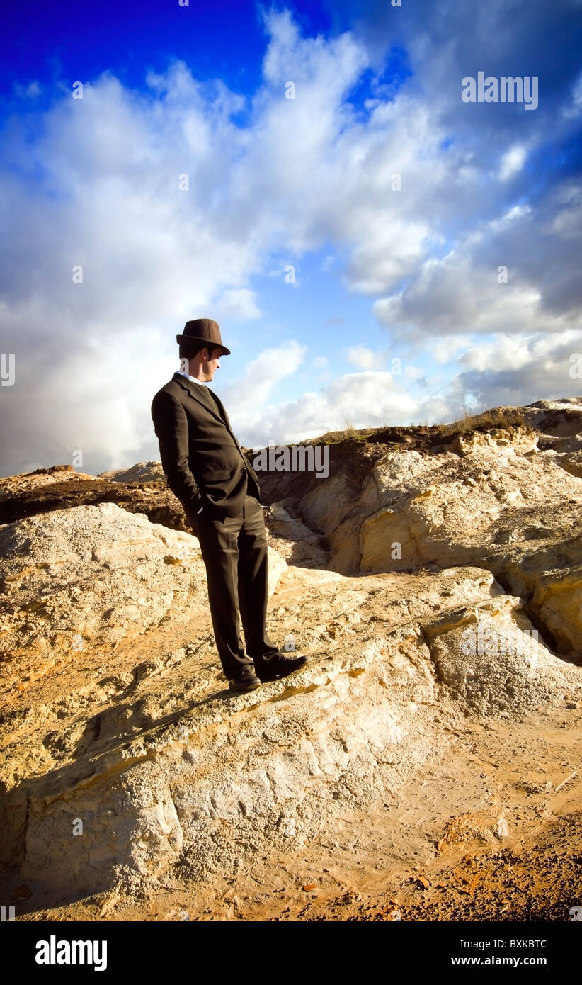 A well dressed man stands in an unusual landscape Stock Photo - Alamy