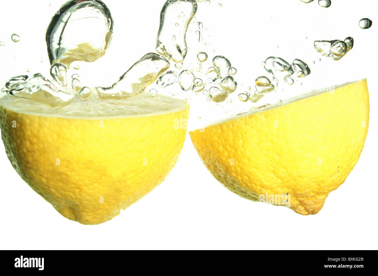 Splash of yellow lemon to water with bubbles of air Stock Photo - Alamy