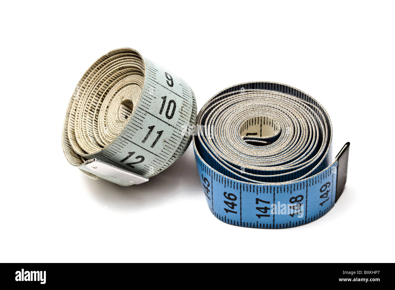 Two tapes measure isolated on white background Stock Photo - Alamy