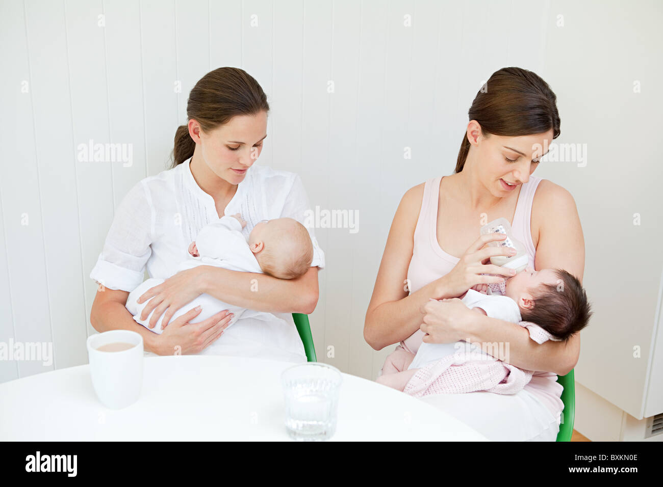 Two mothers with their babies Stock Photo - Alamy