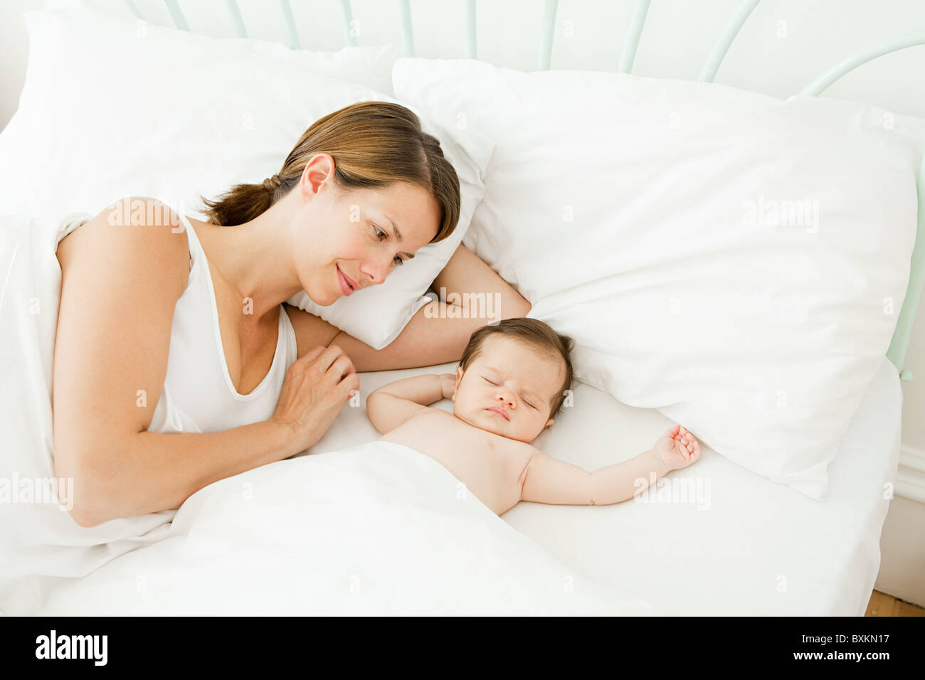 Mother watching baby sleeping Stock Photo - Alamy