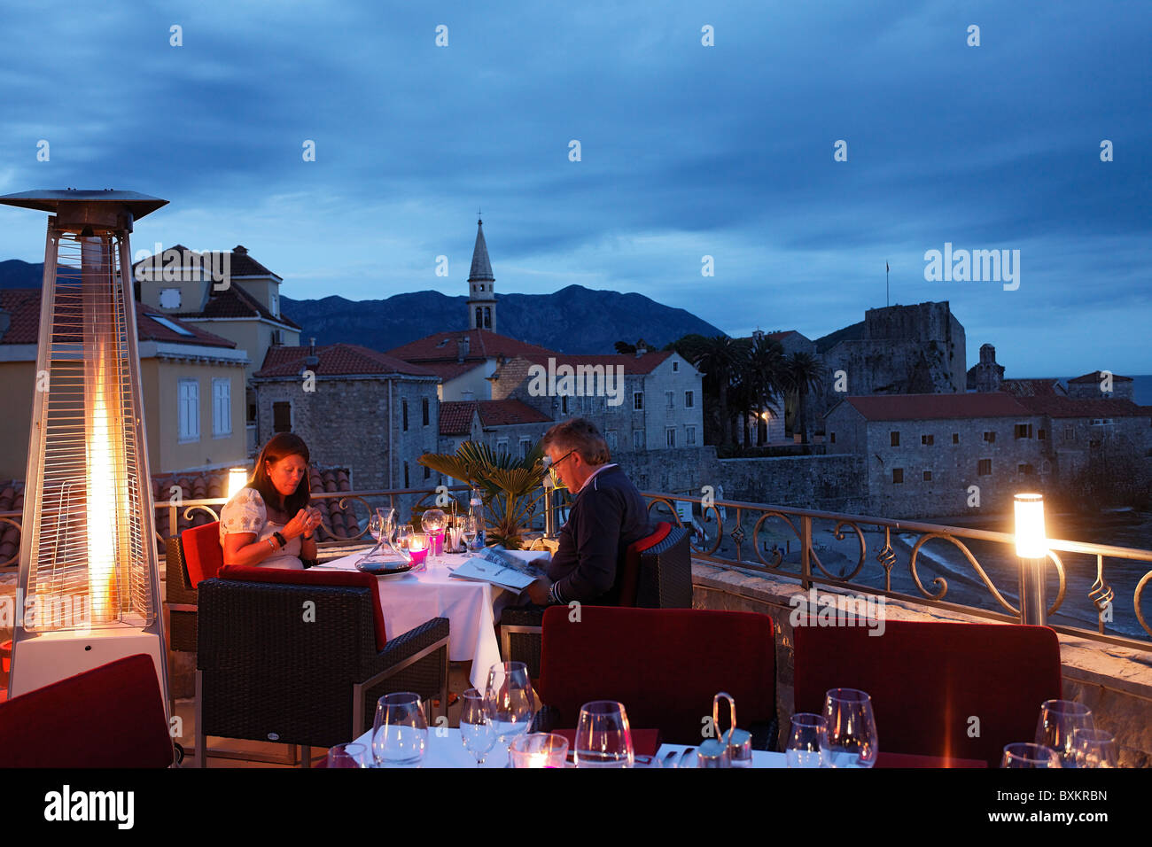 Couple on the terrace of the Astoria Restaurant, view on Citadel, Old ...