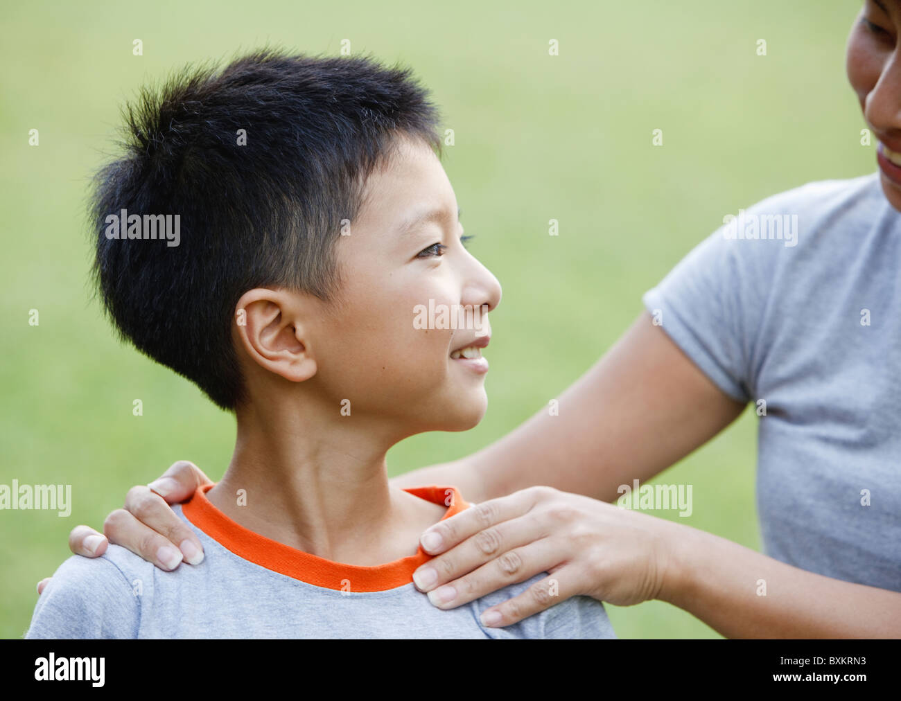 A boy put hands on his his shoulder Stock Photo - Alamy
