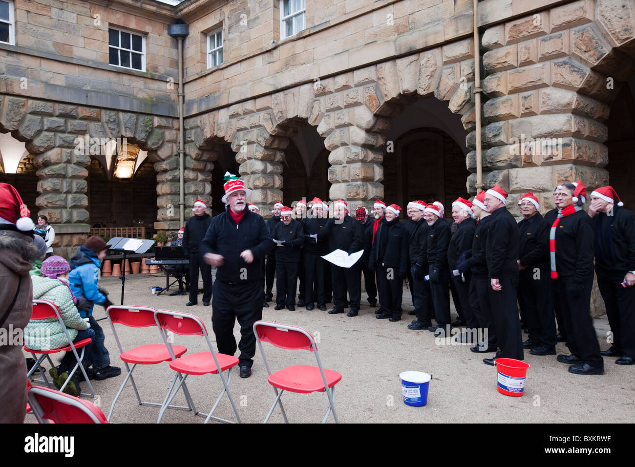 People enjoying a choir of male Carol singers in the Courtyard at ...